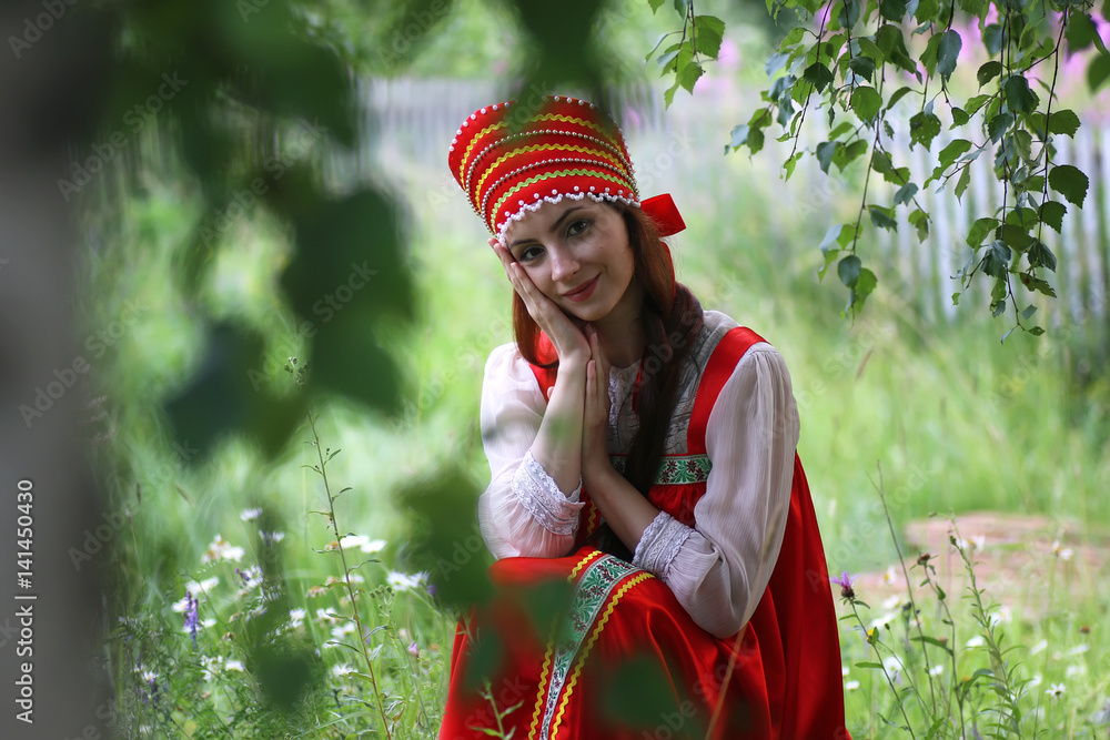 Slav in traditional dress is sitting in nature Stock Photo | Adobe Stock