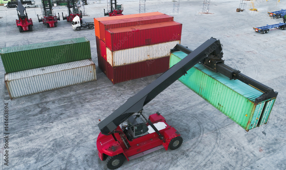 container stacker forklift working on lifting unit of container in yard ...