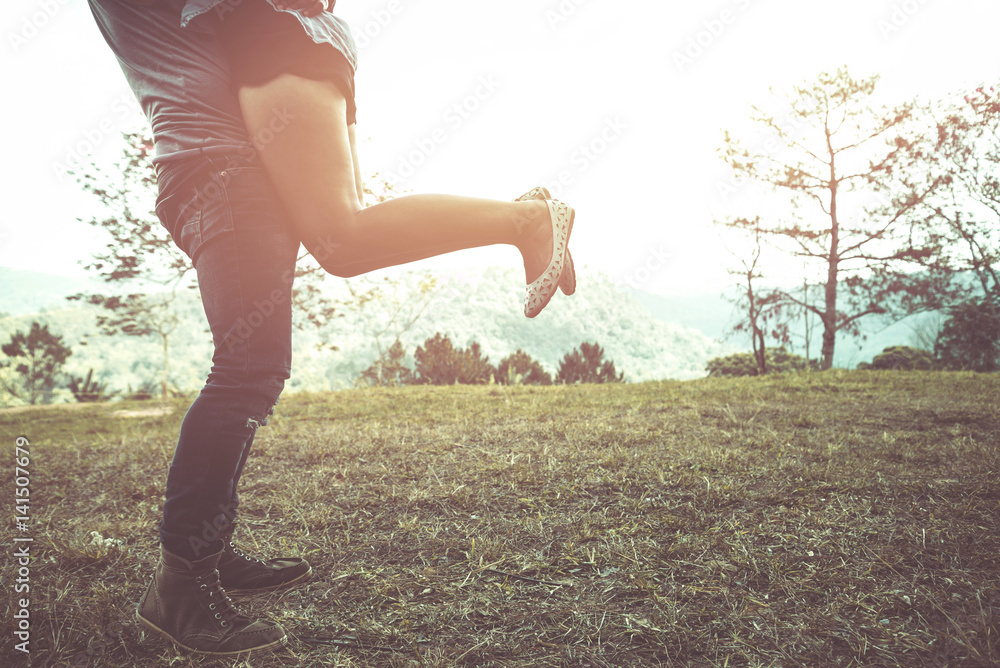 Legs of men with women jumping Hug On the meadow Mountain nature Stock ...