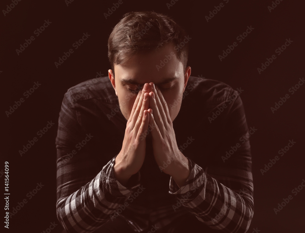 Handsome depressed man on black background Stock-Foto | Adobe Stock