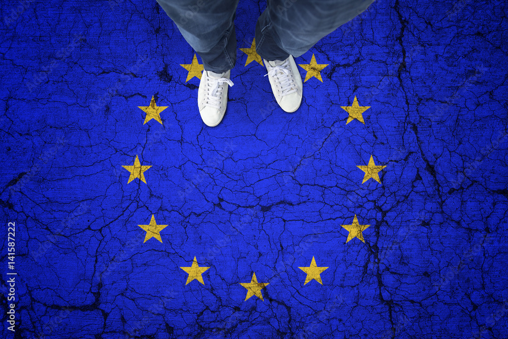 Top view of a man standing on damaged cracked floor with painted Europe ...