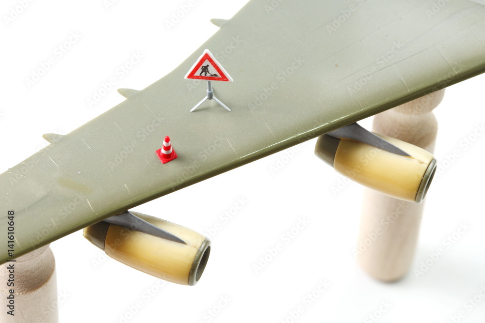 The wing of model toy plane and traffic cone plastic model represent ...