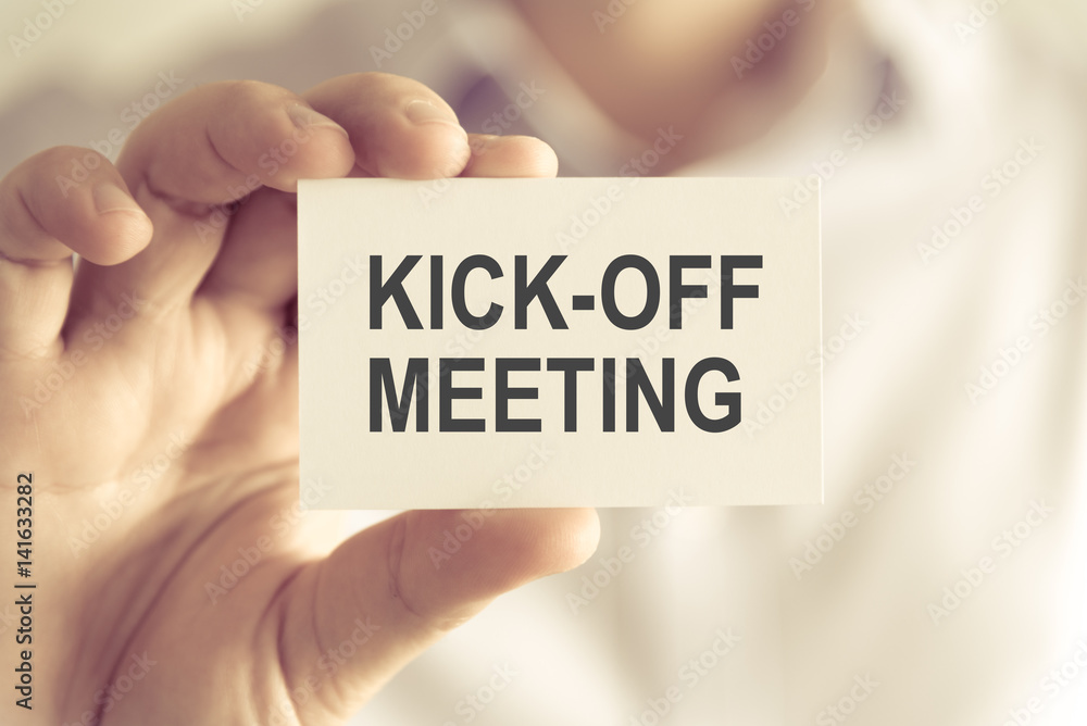 Businessman holding KICK-OFF MEETING message card Stock Photo | Adobe Stock