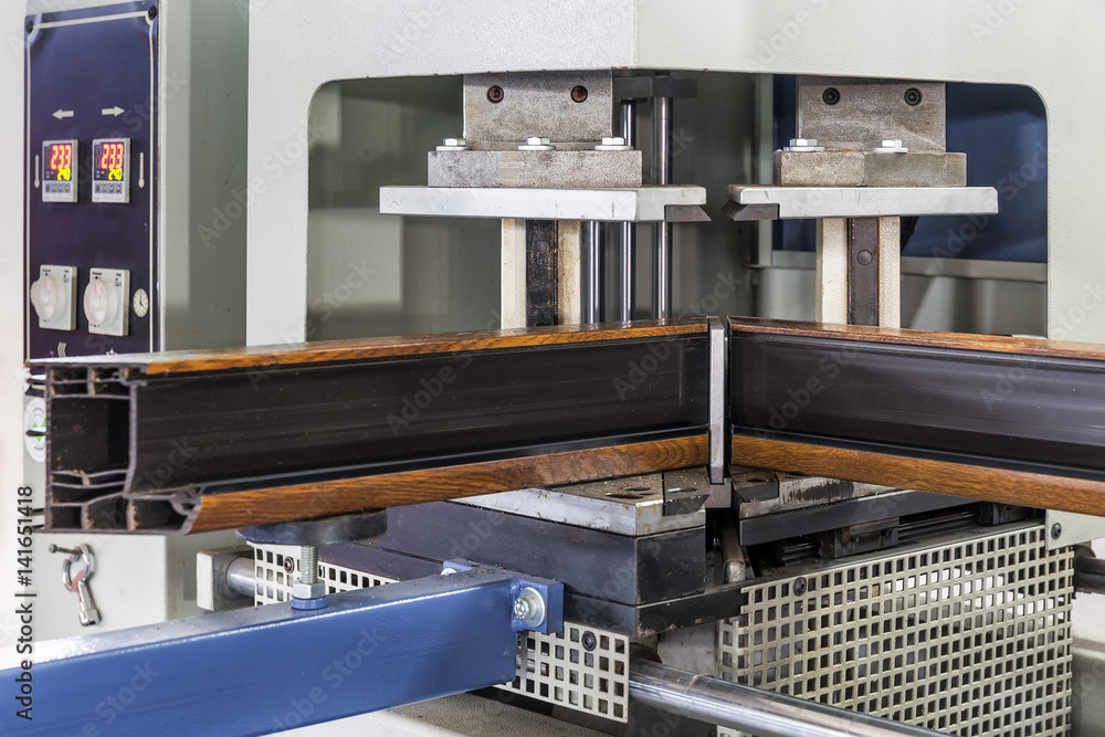 PVC profile production facility. Production windows pvc, man screwed ...