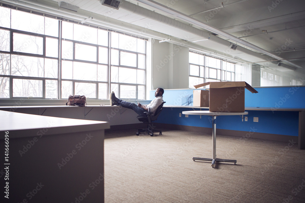 Man using smartphone while sitting on chair in office Stock Photo ...