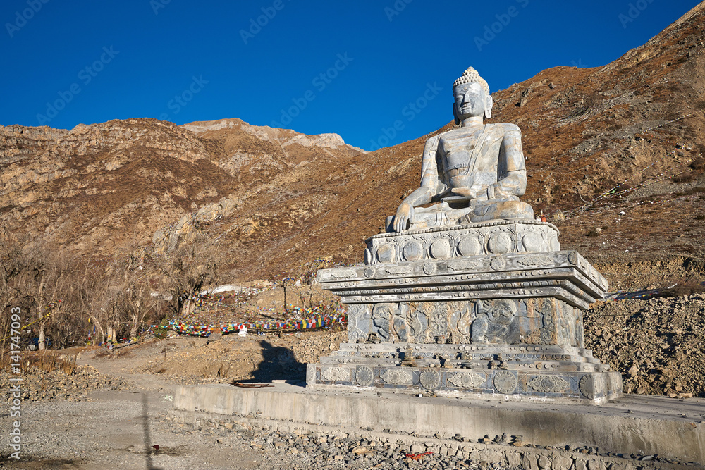 Shakyamuni Buddha stone statue in Muktinath temple complex in Himalayas ...