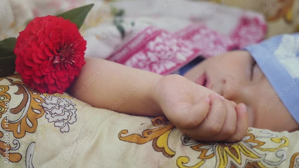 Happy cute child sleeping at flower outdoors in summer garden on a ...