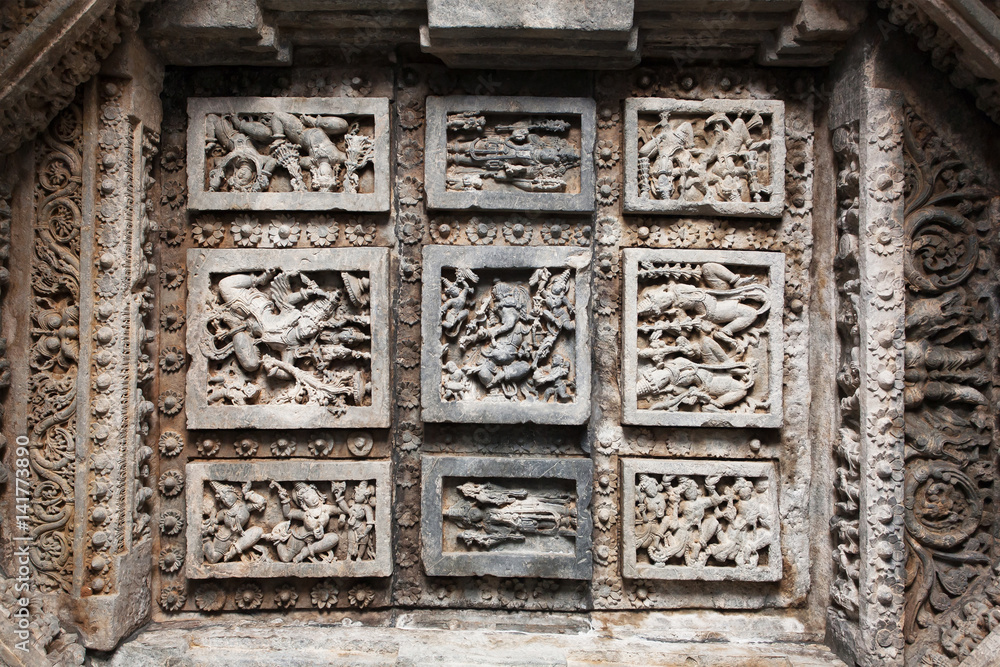 Dancing people, and Ganesh with Shiva lord. Carvings on stone ceiling ...
