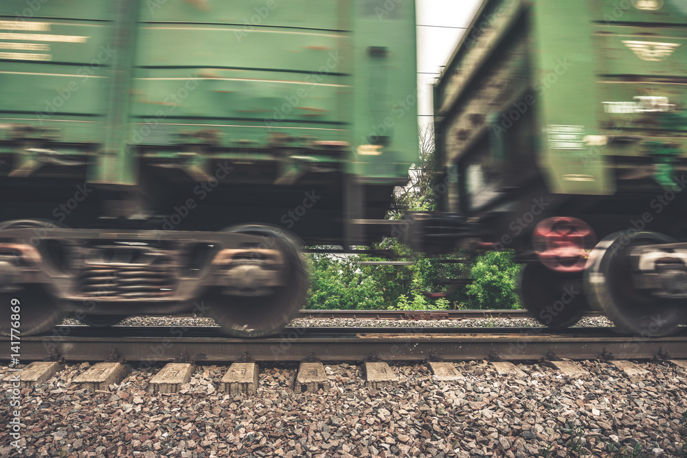 Freight train, wheels, side view, railway wagons with motion blur ...