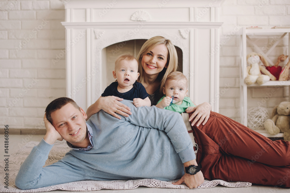 Happy family portrair. Parents with baby two boys twins.Portrait of ...