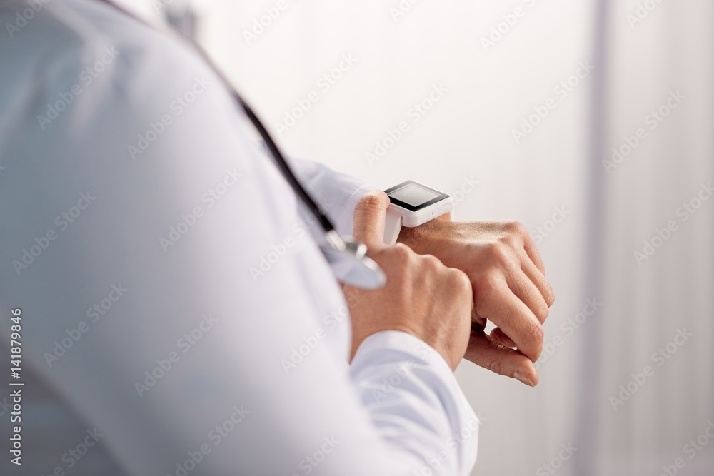 Doctor using smartwatch Stock Photo | Adobe Stock