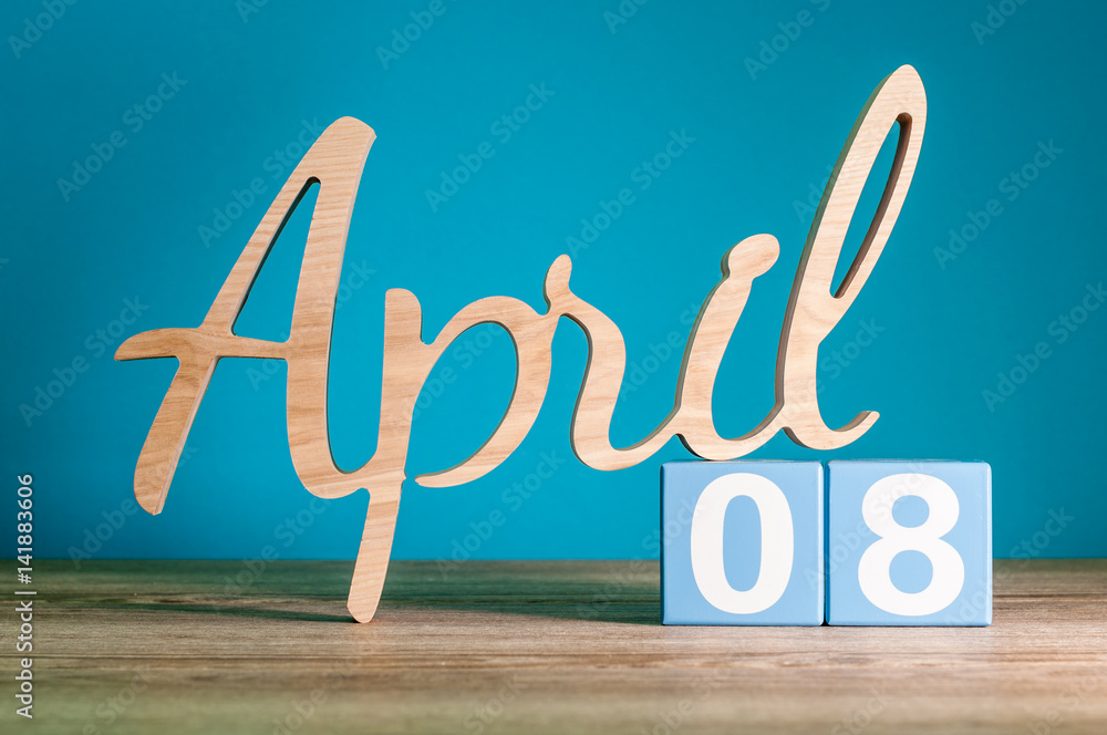April 8th. Day 8 of month, daily calendar on desk with blue background ...