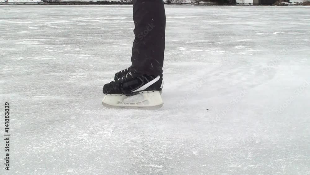 Mens legs in black hockey skates in running speed with ice spray Stock ...