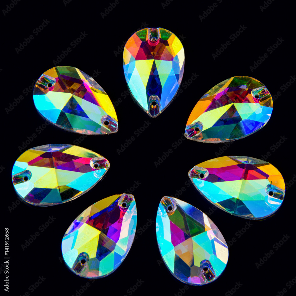 Precious stones crystals in the shape a tear drop on a black background ...