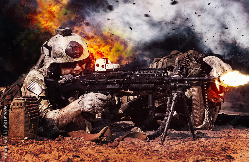 Two crewman of machine gun crew firing in the desert. Explosions fire ...