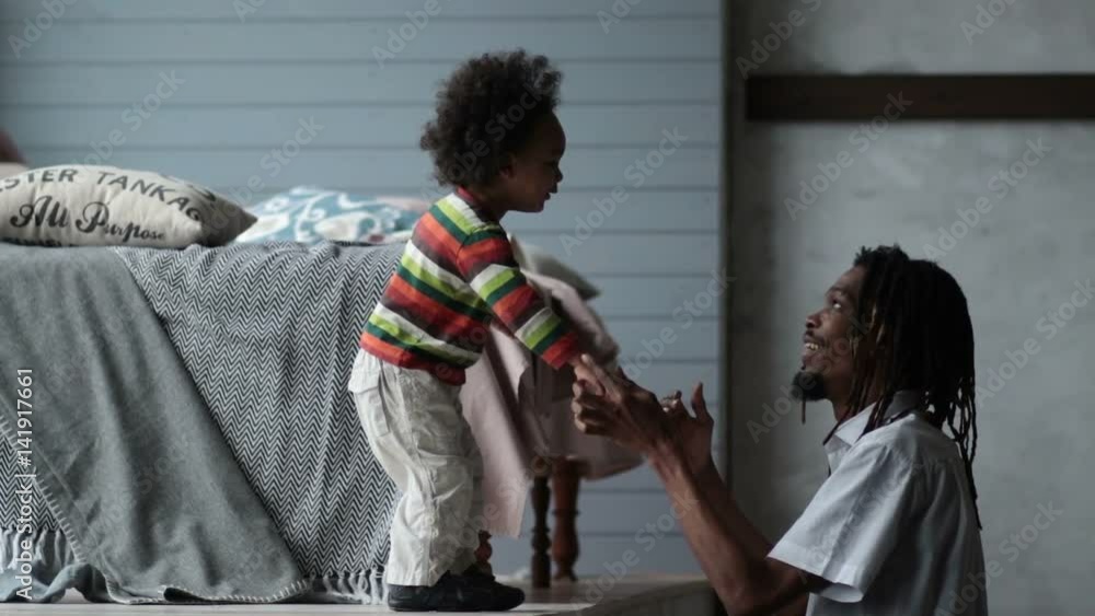 Playful hipster dad playing with his son at home Stock Video | Adobe Stock