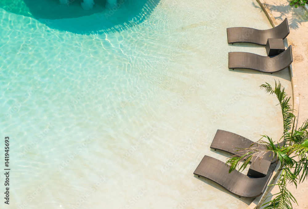 Beach chairs in luxury swimming pool. Stock Photo | Adobe Stock