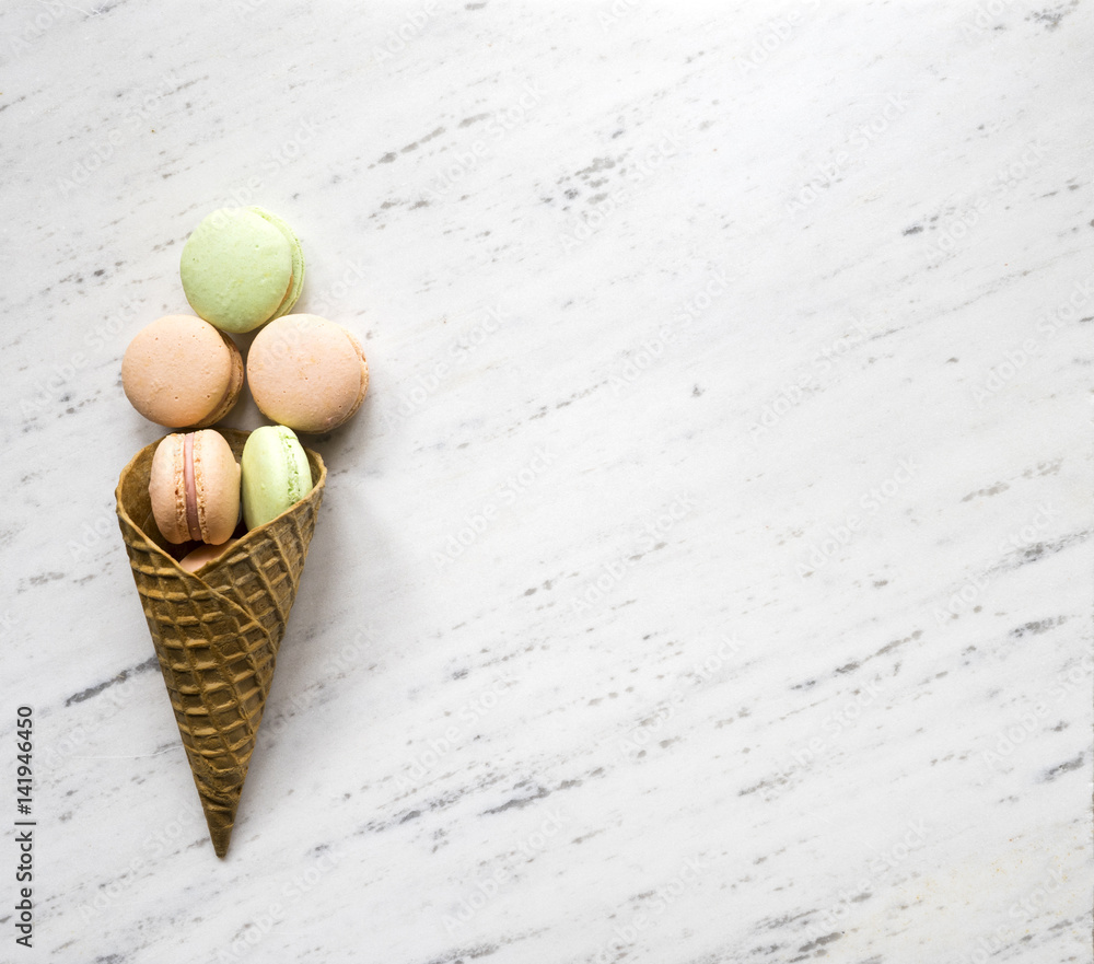 Colorful macaron in ice cream cone of waffle on marble background Stock ...