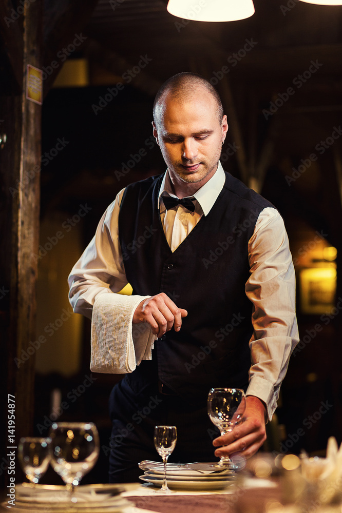 Waiter served table in the restaurant before the feast,Waiter in ...