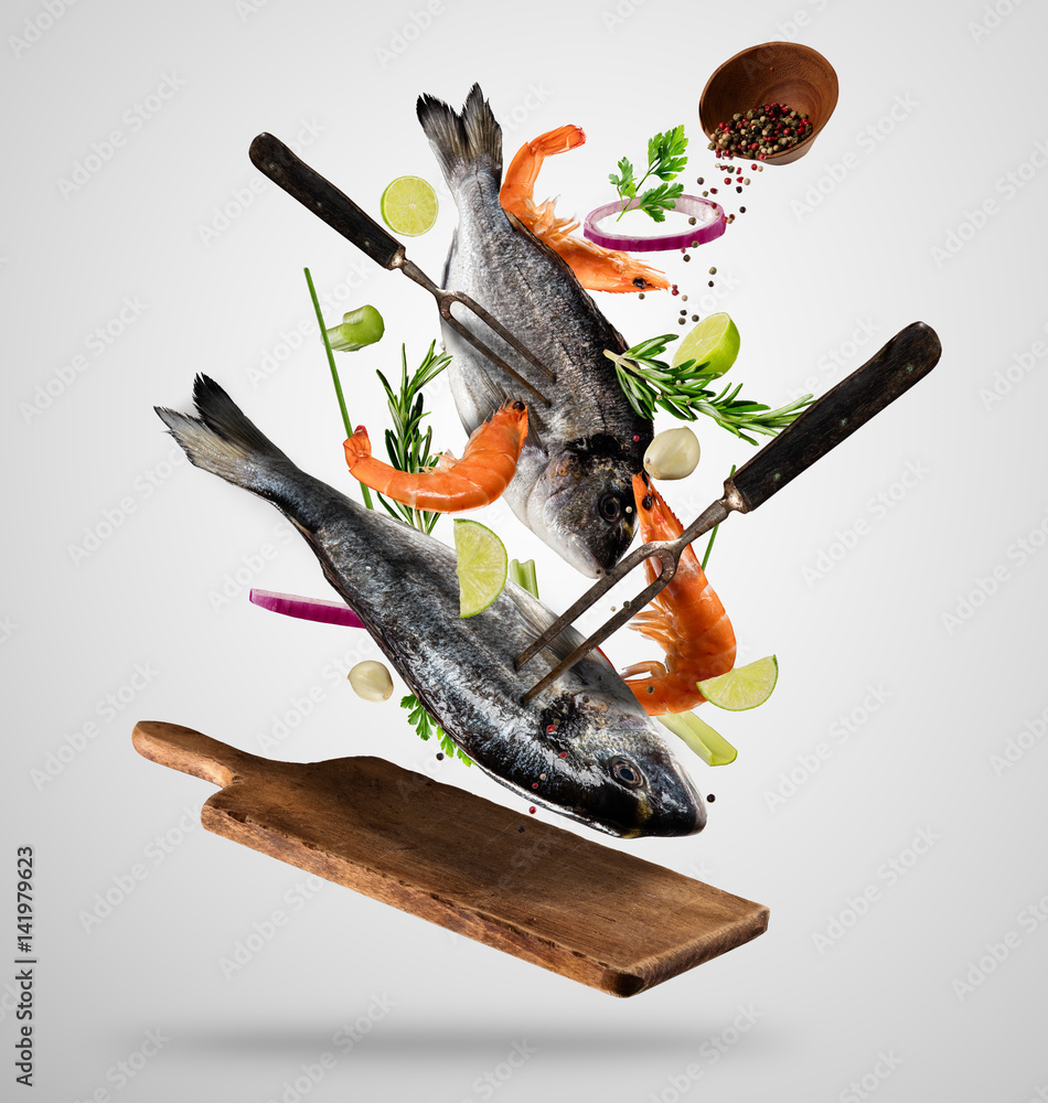 Flying raw whole bream fish and prawns with ingredients Stock Photo ...