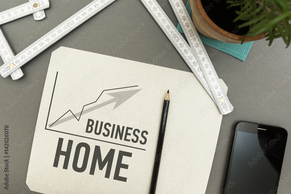 Folding ruler, a blank sheet of paper and a pencil on a gray background ...