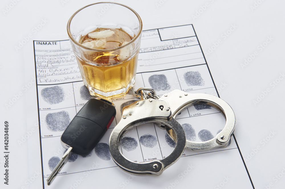 Handcuffs with fingerprints keys and glass of alcohol on ice Stock ...