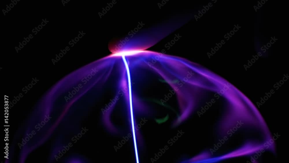 Close-up view of plasma ball with moving energy rays inside on black ...