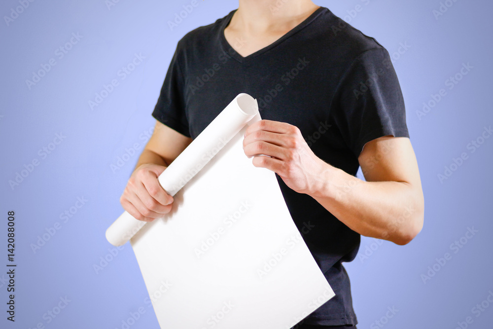 Guy holds in his hands twisted up in paper. Opens the package of paper ...