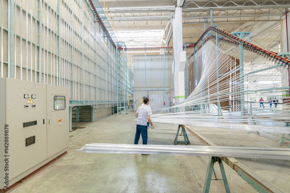 drying of aluminum profiles on a conveyor belt. workers fold the ...