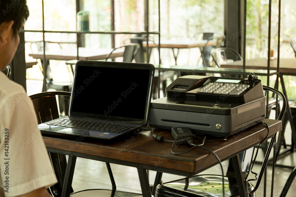 Cashier operating man set up cash register with notebook Stock Photo ...