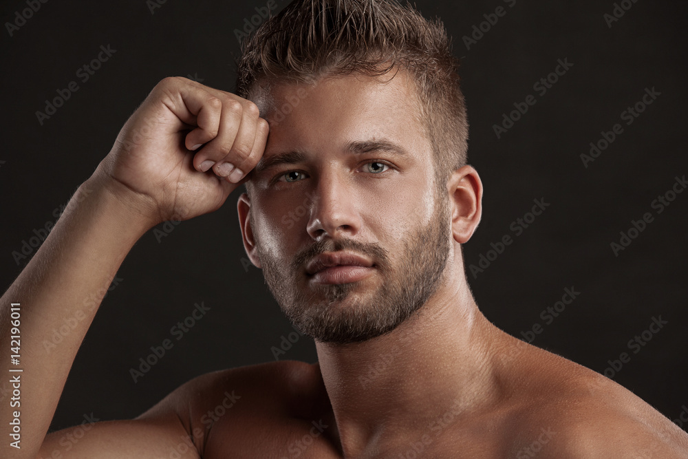 Model man with an open chested on a dark background , muscular body of ...