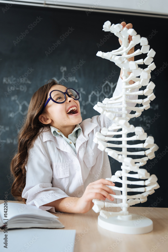 Foto Stock Playful little girl investigating genetic code modifications ...