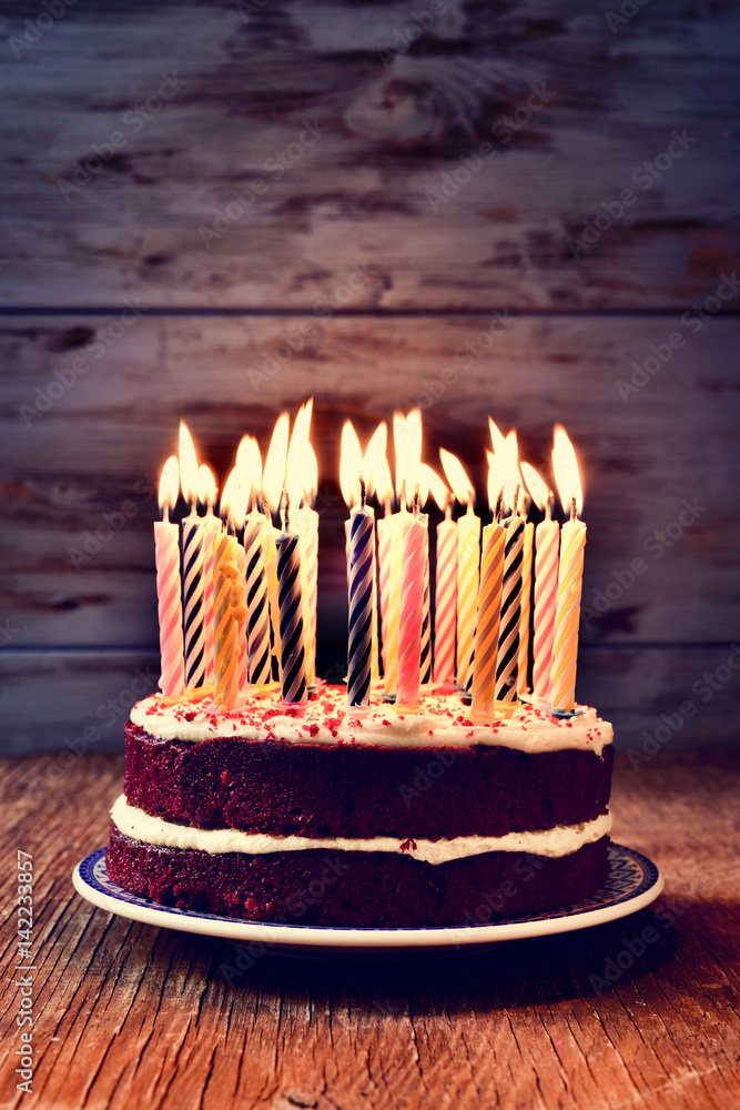 birthday cake with many lit candles Stock Photo | Adobe Stock