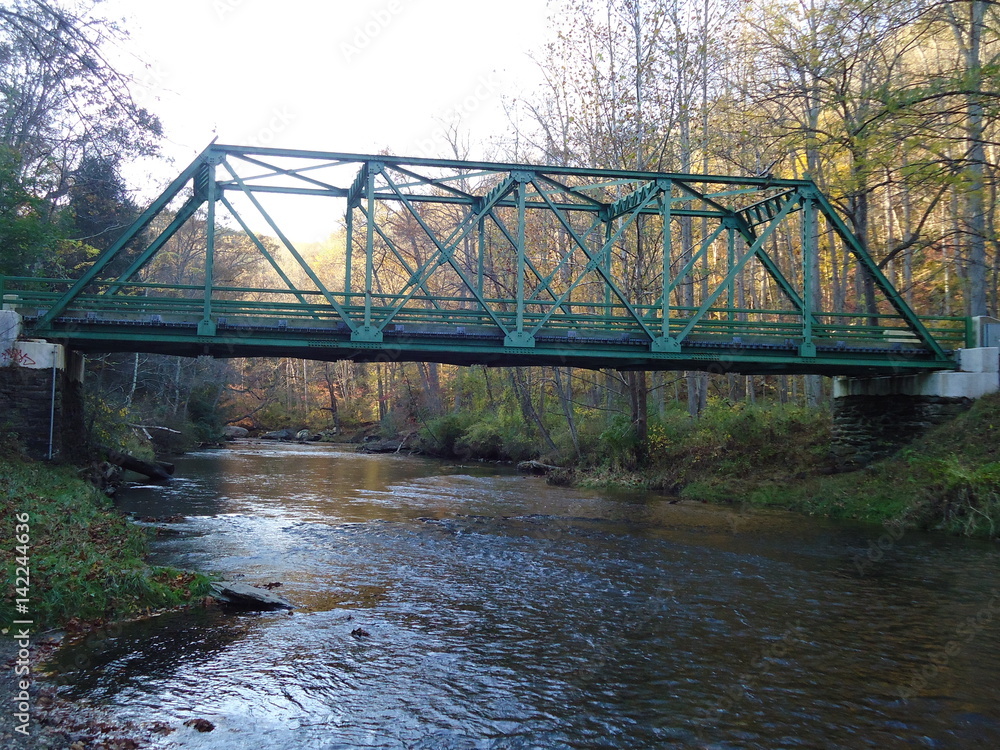 Bridge/Trestle spanning a deep and wide creek filled with water. Stock ...