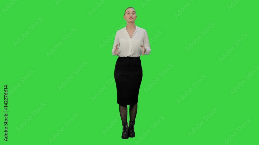 Young pretty woman presents something on a Green Screen, Chroma Key ...