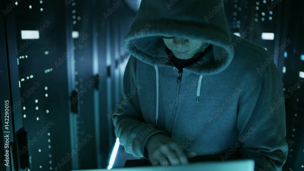 High Angle Shot of Computer Hacker in Hoodie, Holding Laptop. He ...