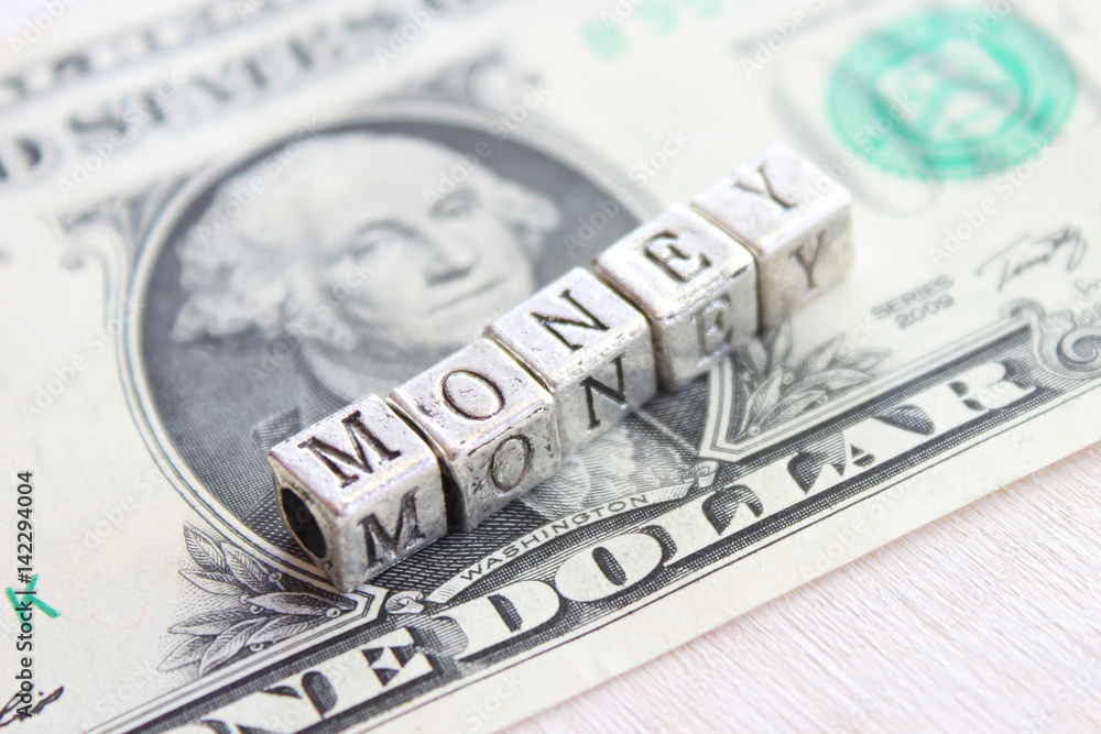 Inscription Money from metall letters on dollar banknote background ...