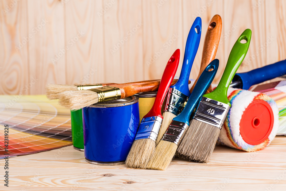 Painter and decorator work table with house project, color swatches ...