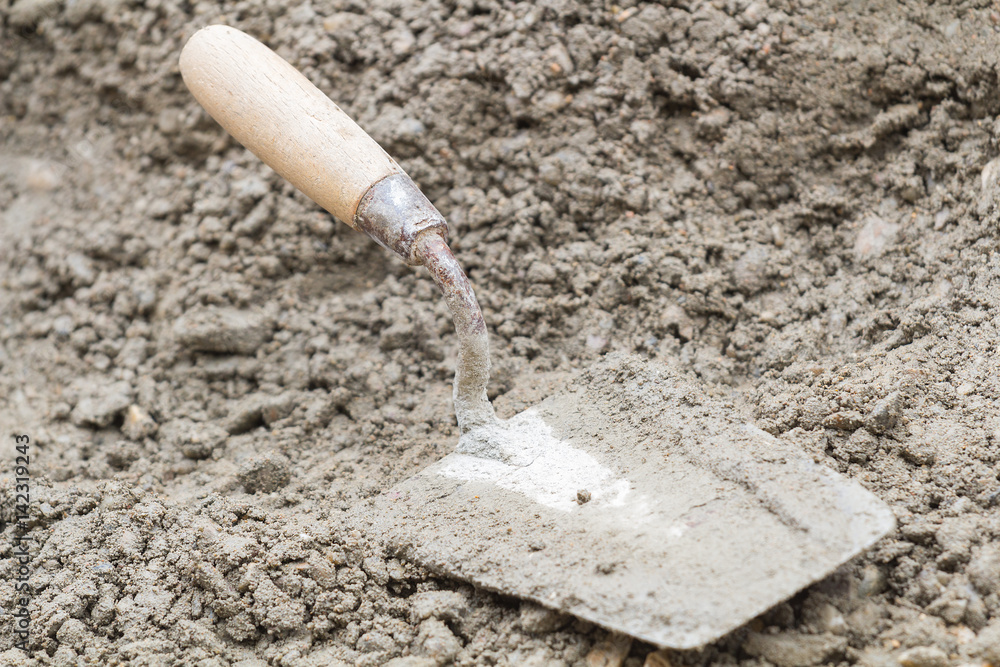 Construction throwel tool on a sand / cement. Stock Photo | Adobe Stock