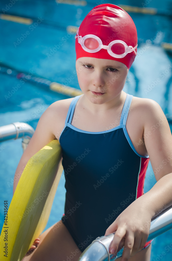 Young girl learning to swim in the pool Stock Photo | Adobe Stock