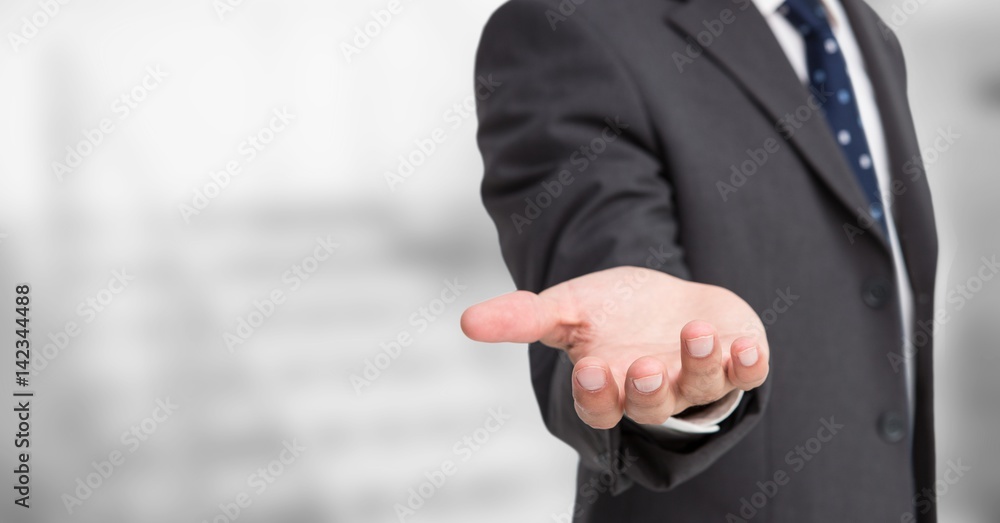 Business man mid section with hand out against blurry grey stairs Stock ...