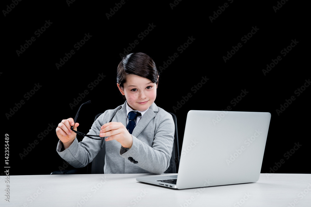 Cute little boy in formal suit and eyeglasses working with laptop Stock ...