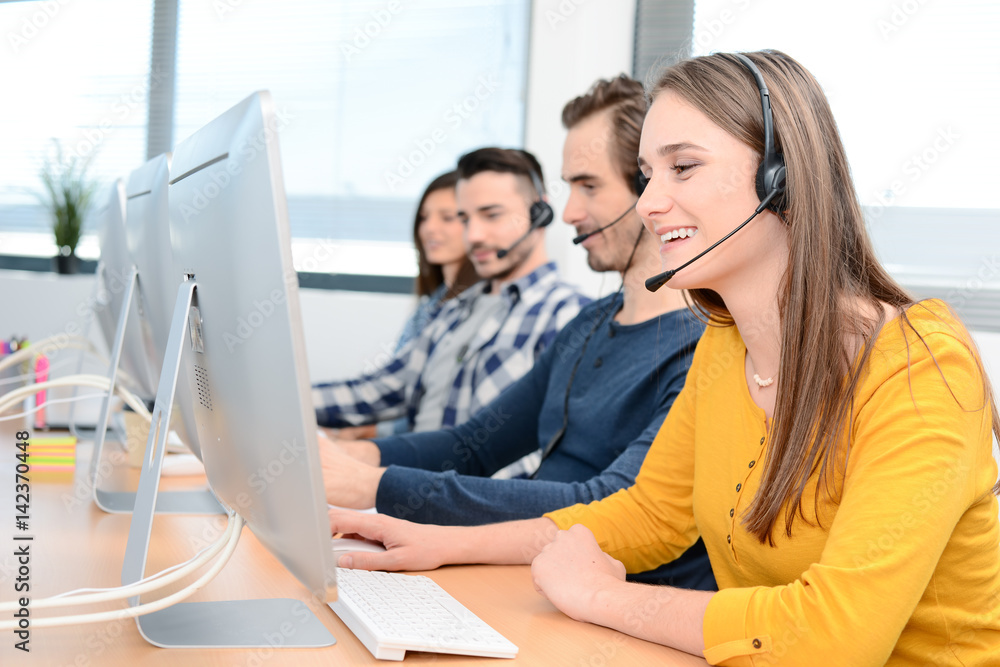 group of young people telephone operator with headset working on ...