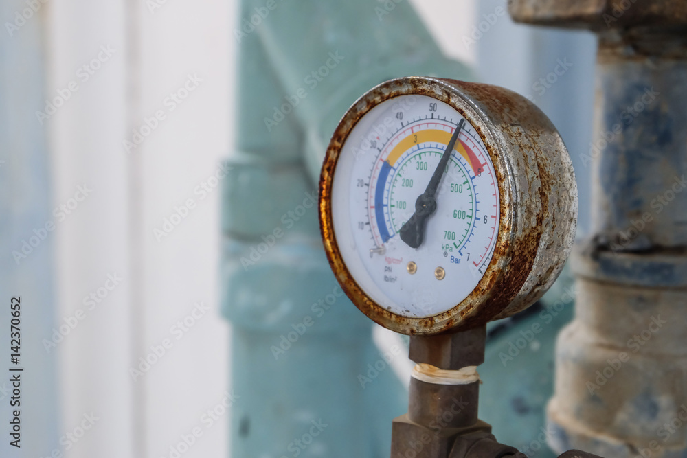Closeup of manometer, measuring gas pressure. Pipes and valves at ...
