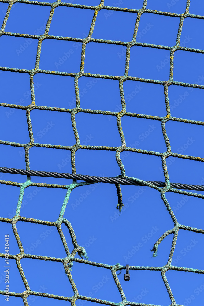 Loch in einem Netz Stock-Foto | Adobe Stock