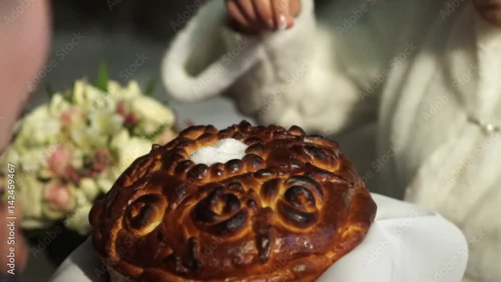 Bread and sault at the Wedding. The groom sprinkles the bread with salt ...