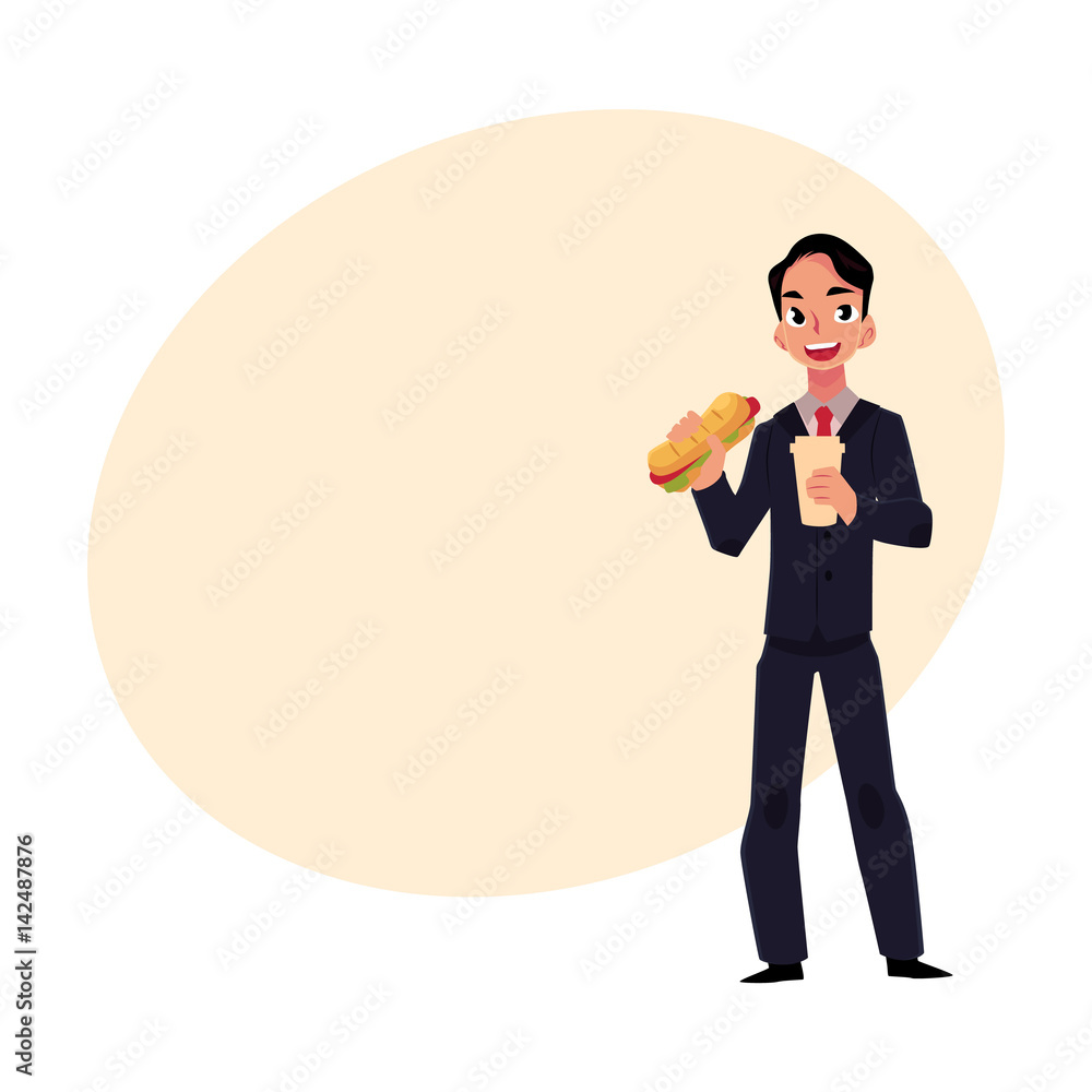 Young businessman in business suit eating sandwich, holding coffee cup ...