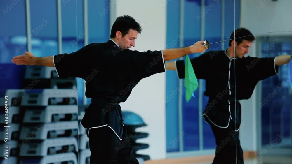 Young man training his skills in moving the sword in the gym Stock ...