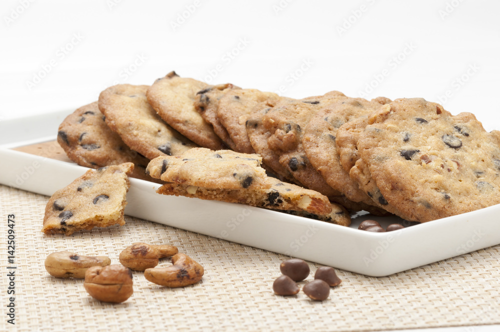 Chocolate chip cookies on white tray with coffee tea infusions art ...