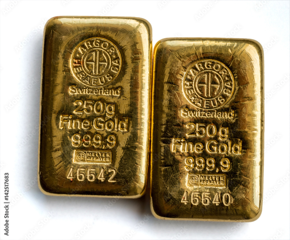 Two cast gold bars weighing 250 grams each on a light background ...
